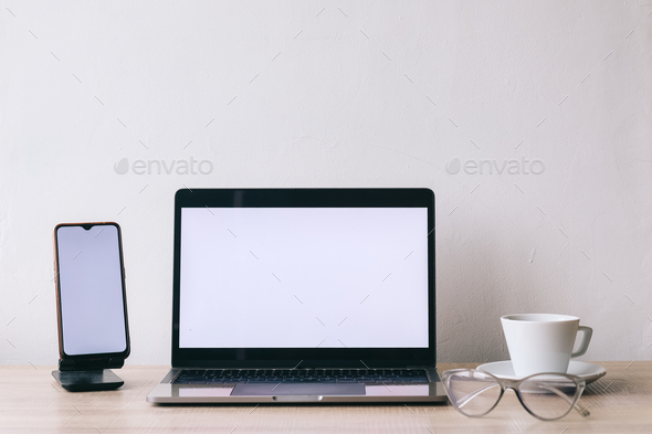 Place it - White blank screen laptop and smartphone with coffee and ...