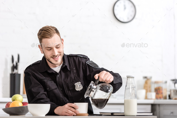 smiling police officer pouring filtered coffee from glass pot at ...