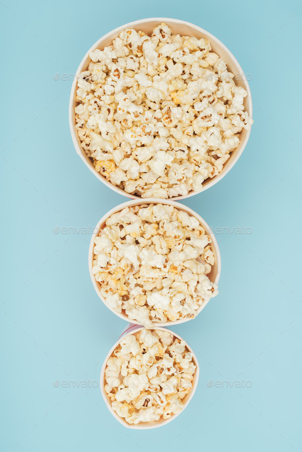 top view of popcorn buckets of different sizes in vertical row isolated ...