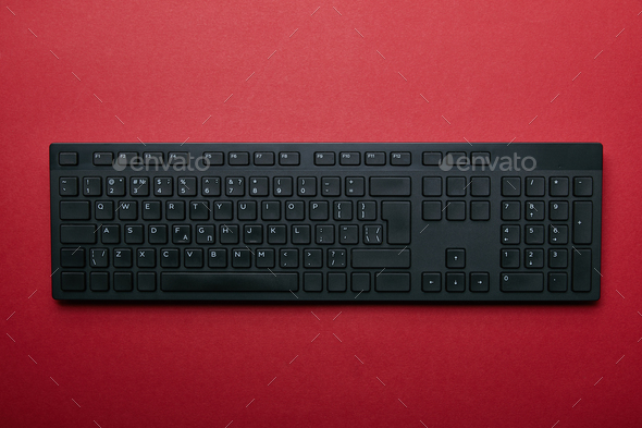 Top view of black plastic computer keyboard on red background Stock ...