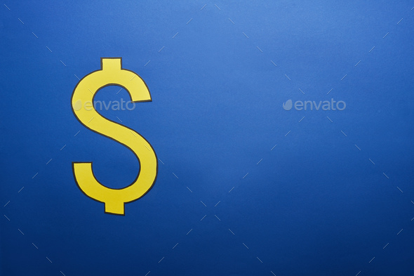 elevated view of yellow dollar sign on blue background Stock Photo by ...