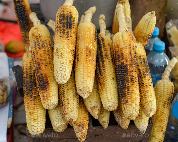Elote roasted on charcoal. Mexican street food Stock Photo by ...
