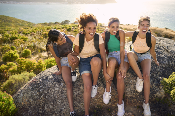 Female Friends With Backpacks On Vacation Taking A Break On Hike ...