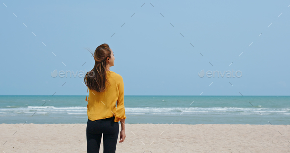 Woman look at the sea with clear blue sky Stock Photo by leungchopan