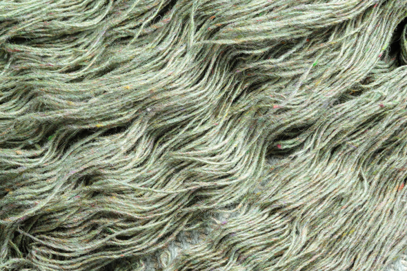 Threads of natural organic sheep wool. Unwound skein of olive green ...