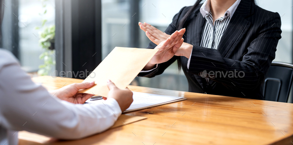Authorities raising his hand refusing to accept bribes from customer ...