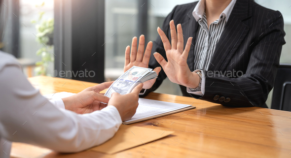 Authorities raising his hand refusing to accept bribes from customer ...