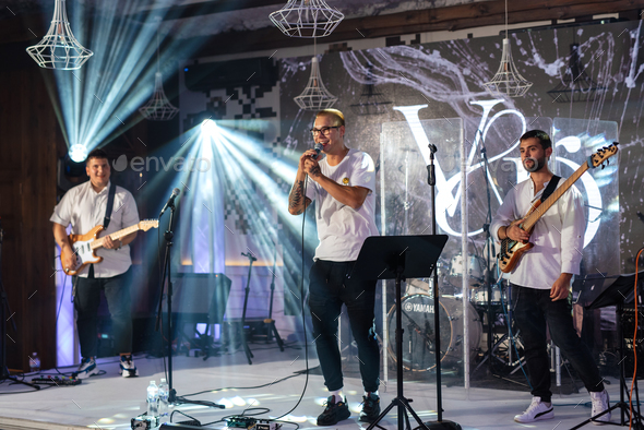 soloist on stage at a concert singing into a microphone Stock Photo by ...