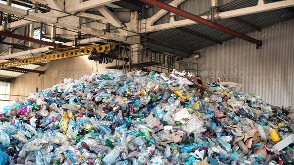 Heap of plastic garbage at waste sorting plant Stock Photo by frimufilms