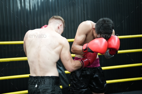 Boxing trainer with a man boxing at the gym. Boxers training kickboxing ...