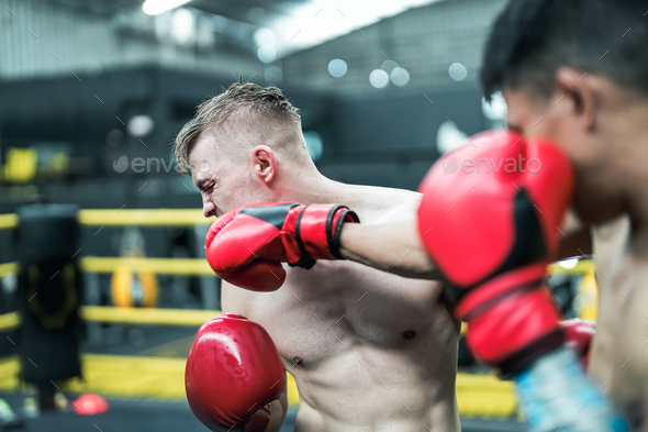 Boxing trainer with a man boxing at the gym. Boxers training kickboxing ...