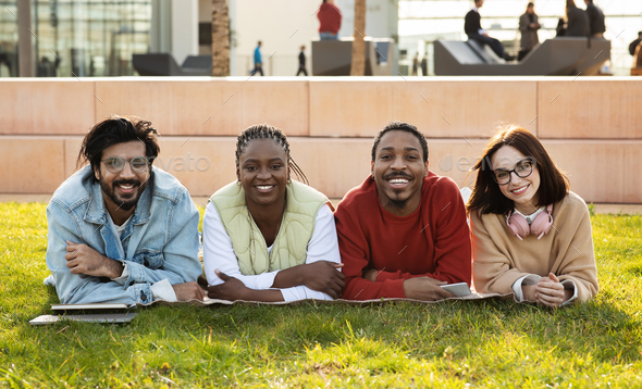 Smiling millennial diverse modern students study together, rest from ...