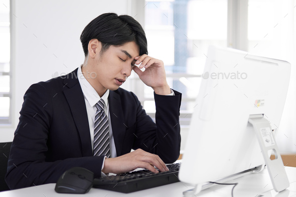 Japanese male businessman with dizziness Stock Photo by cait00sith