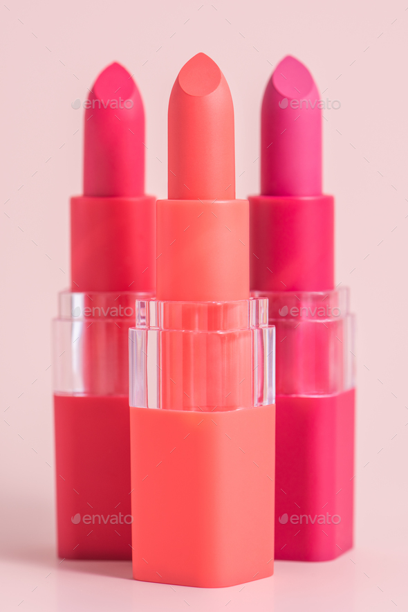 Set of three color lipsticks. Wine lipstick, pink lipstick and orange ...