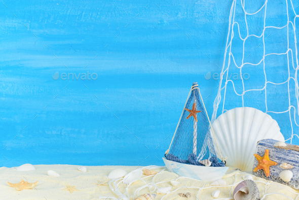 Ship, fishing net, seashells, starfish and chest on sand with copy ...