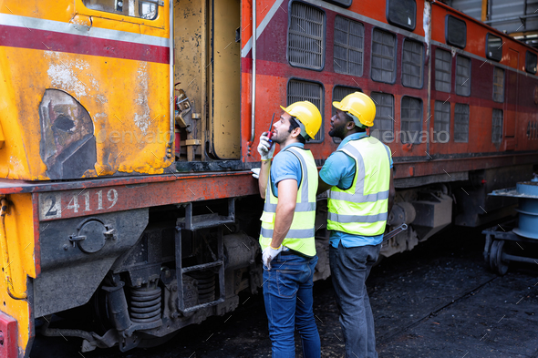 Railroad train maintenance engineer look around discussion with team ...