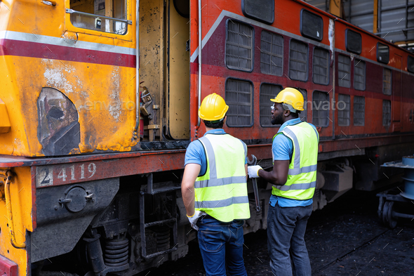 Railroad train maintenance engineer look around discussion with team ...