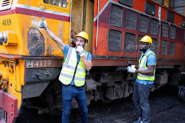 Railroad train maintenance engineer walkie talkie call giving signal to ...