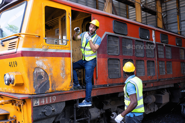 Railroad train maintenance engineer walkie talkie call giving signal to ...