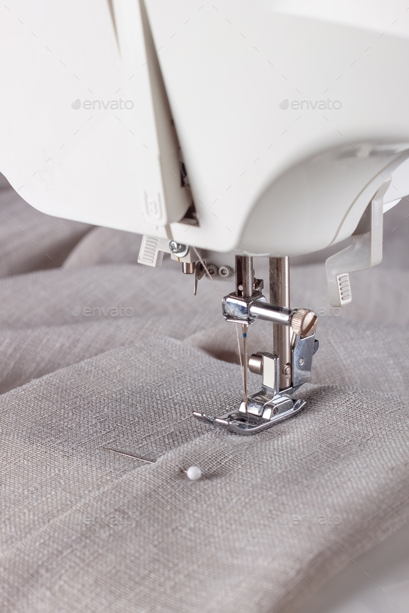 Modern sewing machine presser foot with linen fabric and thread ...