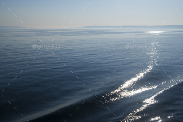 A wake from ferry boat, ripples and reflections on the water. Stock ...