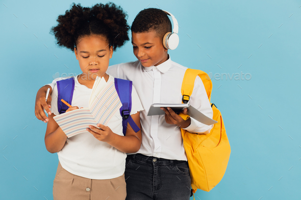 African schoolboy and African American schoolgirl are reading outline ...