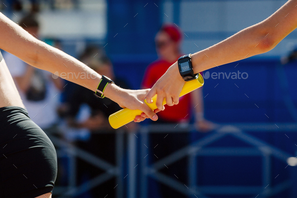 hand women passing baton running relay race in summer athletics ...