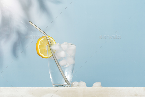 Glass of cold water with ice cubes and lemon slice on the table Stock ...