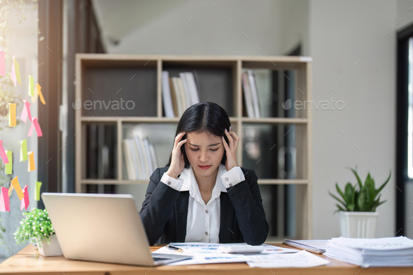 businesswoman are stressed and tired from work sitting at desk in the ...
