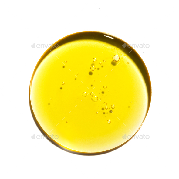Drop of yellow oil swatch texture in petri dish with bubbles, cosmetics ...