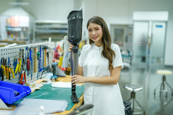 Orthopedic technician making prosthetic leg for disabilities people in ...