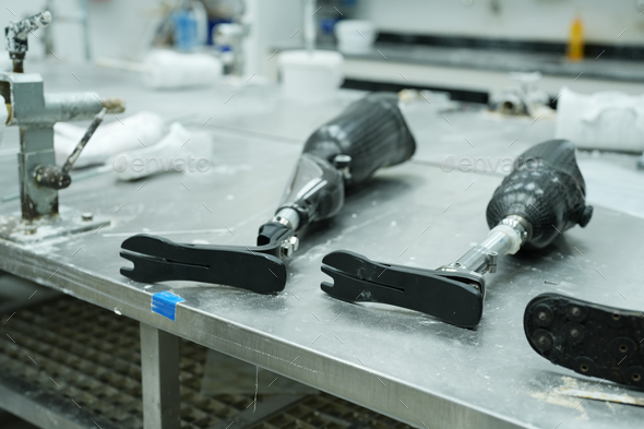 Orthopedic technician making prosthetic leg for disabilities people in workshop. Stock Photo by ...