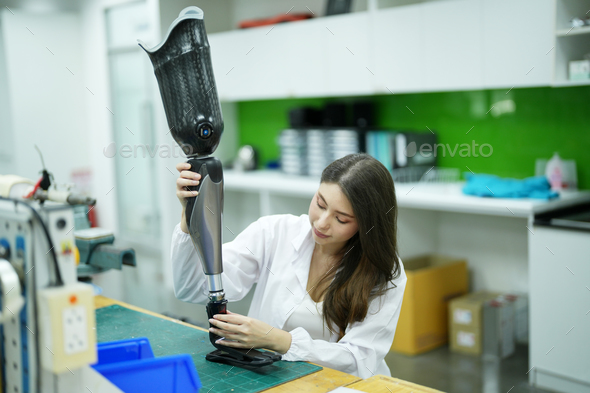 Orthopedic technician making prosthetic leg for disabilities people in workshop. Stock Photo by ...