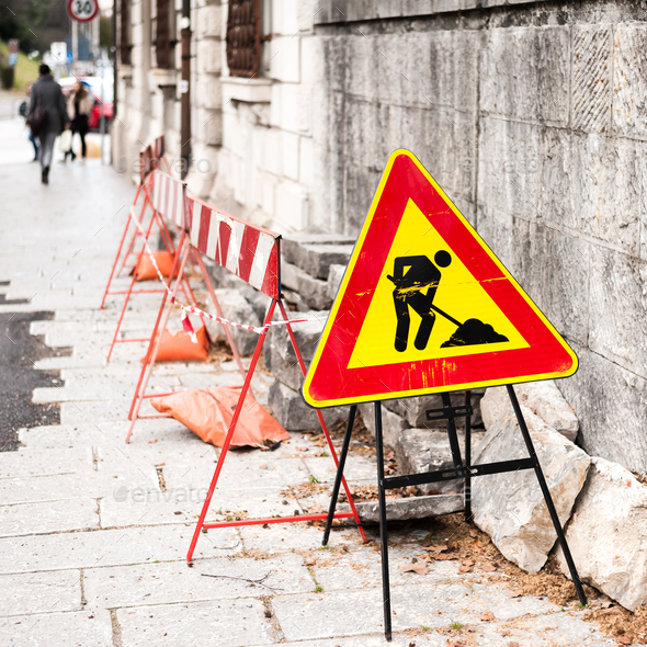 Construction zone sign by the road in urban environment Stock Photo by ...