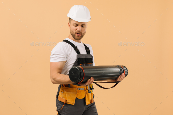 Positive construction engineer shows strength and muscles lifting ...