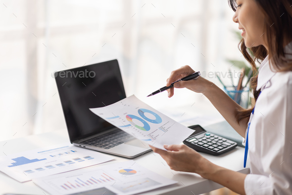 Charming Young asian businesswoman sitting on laptop computer in the ...