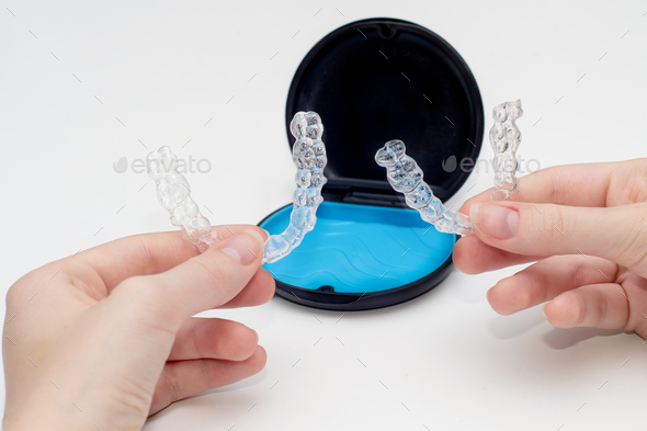 Transparent teeth aligners in a box. Invisible braces. Clear teeth ...