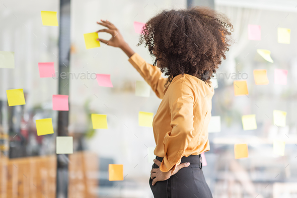Young Asian woman Creative team use post it notes to share idea sticky ...