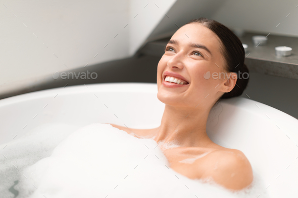 Cheerful Lady Taking Bath Lying In Foam Bubbles In Bathroom Stock Photo ...