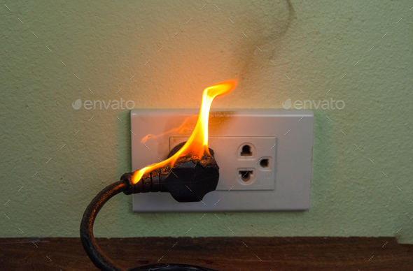 On fire electric wire plug Receptacle wall partition Stock Photo by thichaa