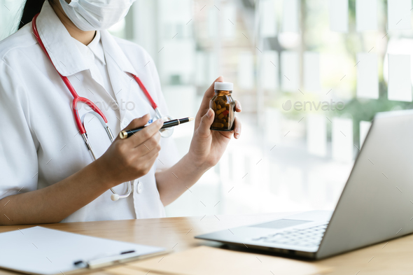 Asian female doctor using laptop computer online video call remote ...