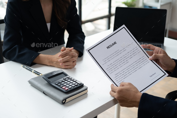Human resources reviewing resume during job interview in the office ...