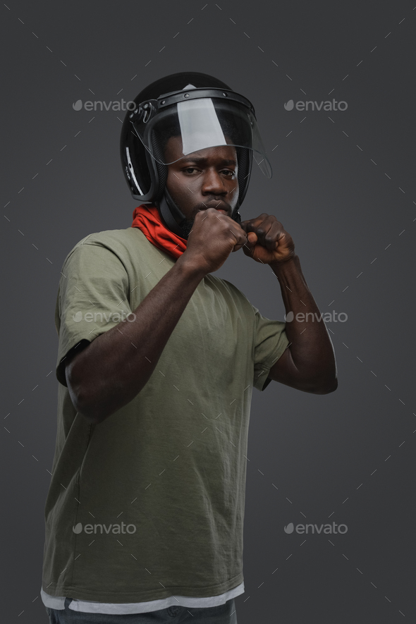 Aggressive african rebel man with helmet in fight stance Stock Photo by ...