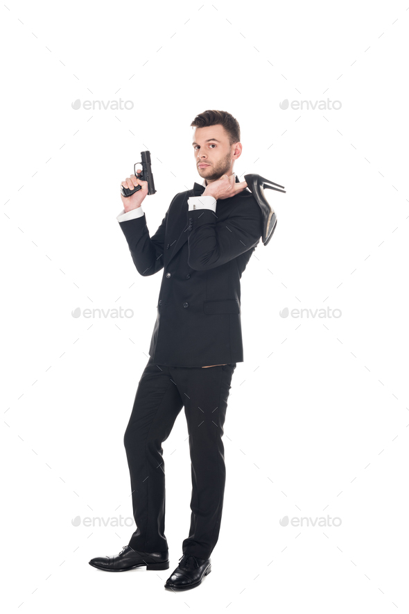 elegant secret agent in black suit holding handgun and high heels ...