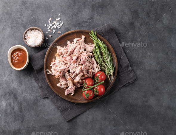 Traditional barbecue torn pork meat with bbq sauce, fresh tomatoes and ...