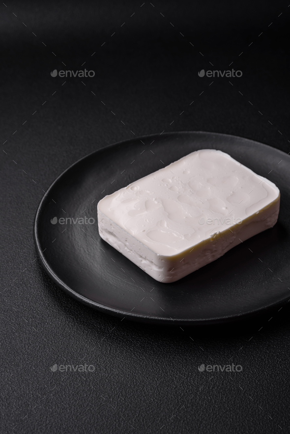 Delicious fresh rectangular shaped feta cheese with spices and ...