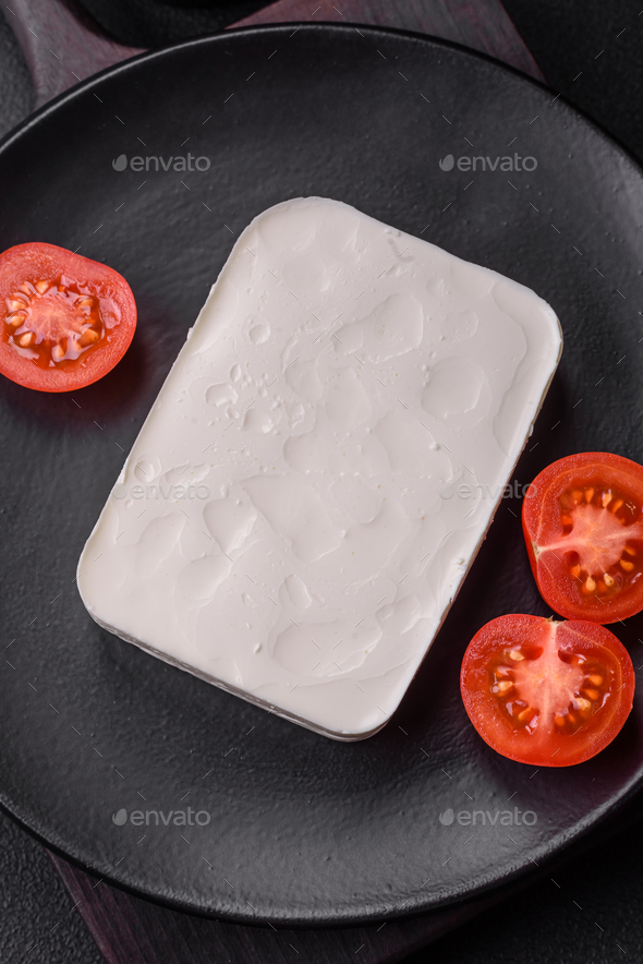 Delicious fresh rectangular shaped feta cheese with spices and ...