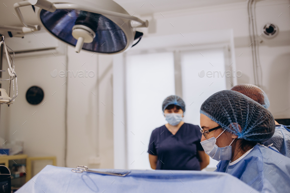 Doctor during surgery in operating room. Professional female doctor ...
