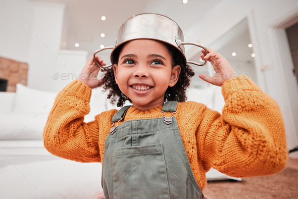 Children, playing and a girl with a pot on her head in the living room ...