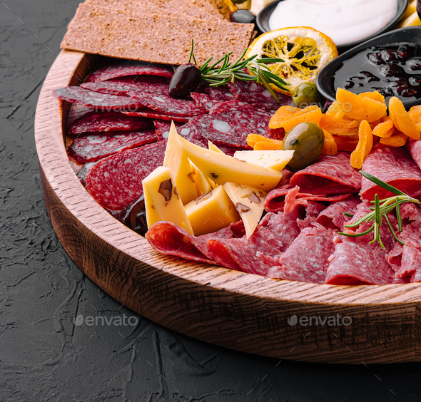 Wooden tray selection of italian antipasti Stock Photo by AntAlexStudio
